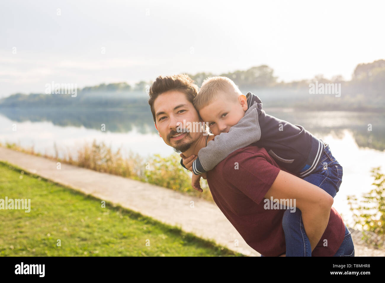 Family, childhood, fatherhood concept - Father piggyback his little son ...