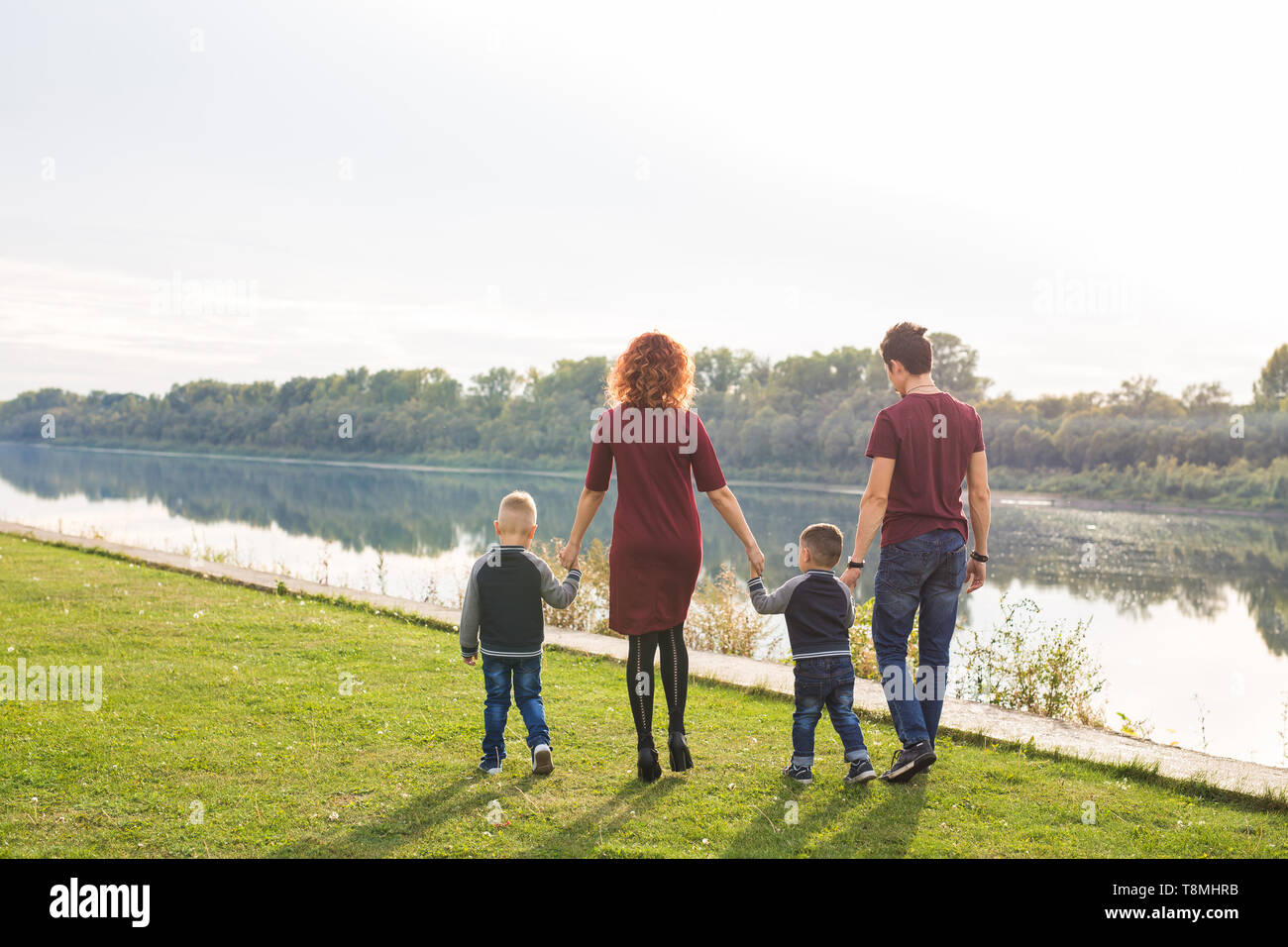Parent, childhood and nature concept - Family playing with two sons by ...