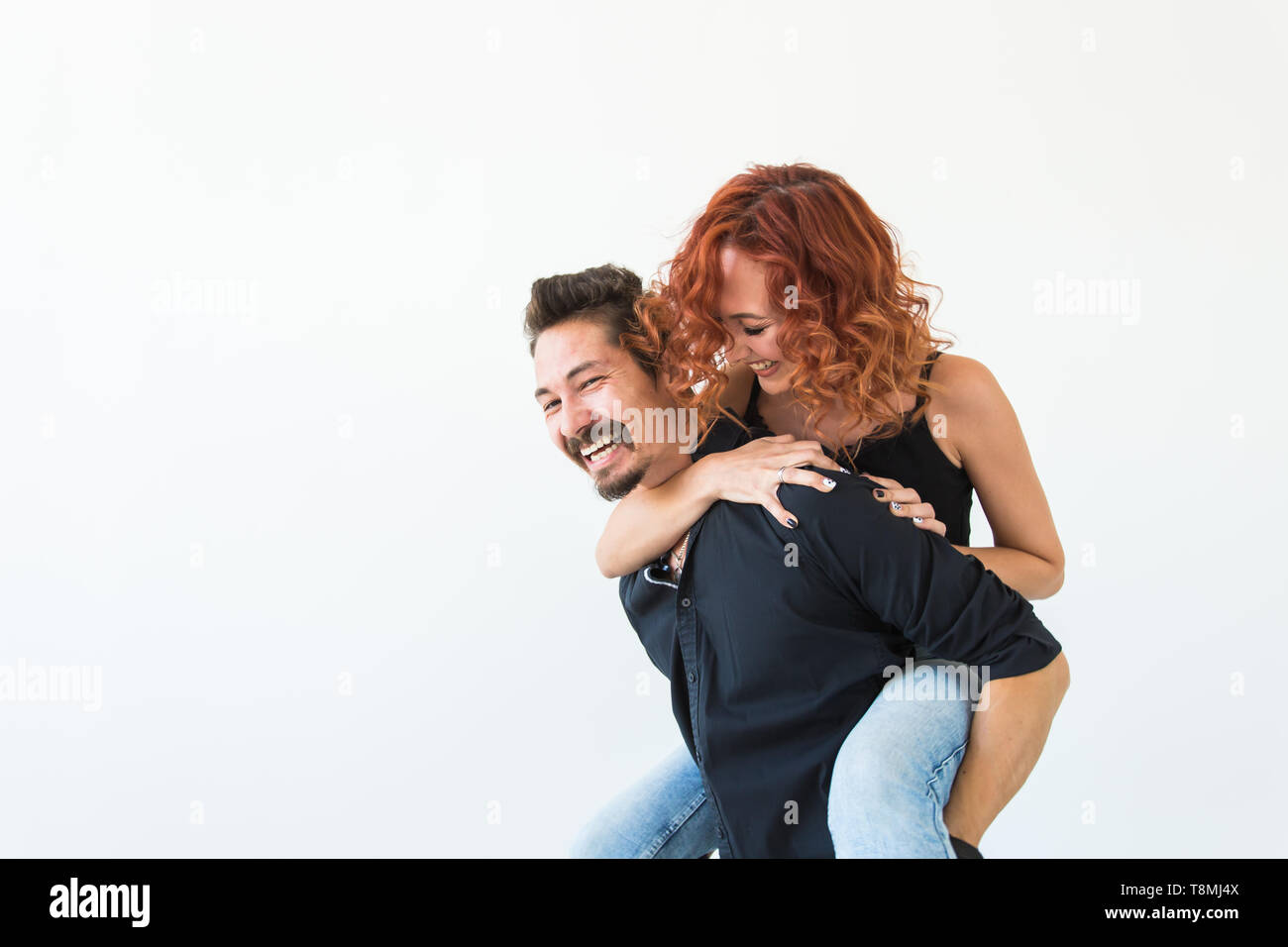 People and love concept - Beautiful pretty woman sitting at man's back ...