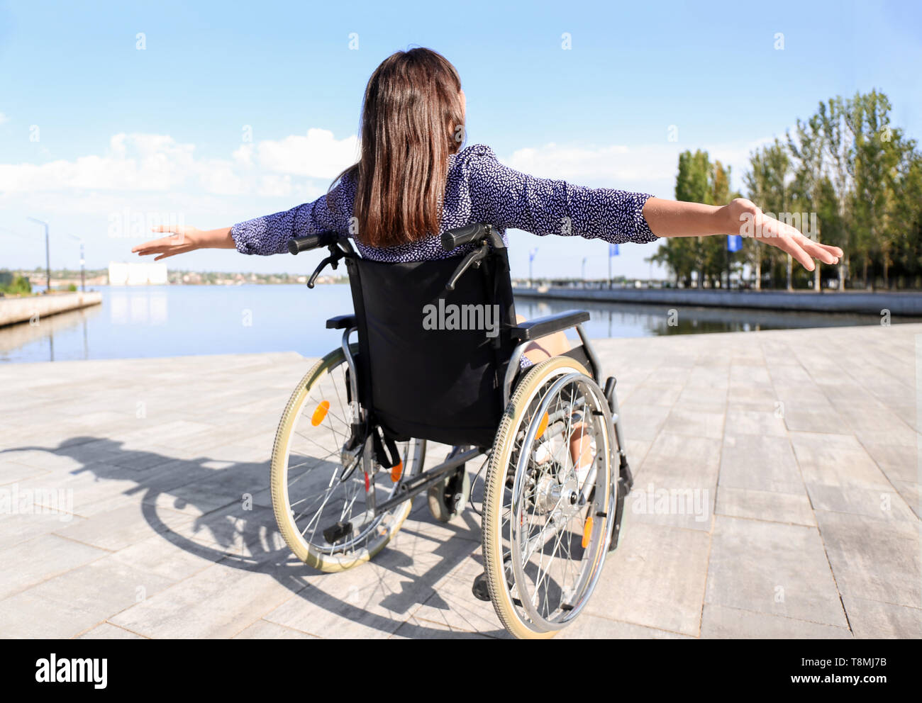 Happy young woman in wheelchair outdoors Stock Photo - Alamy