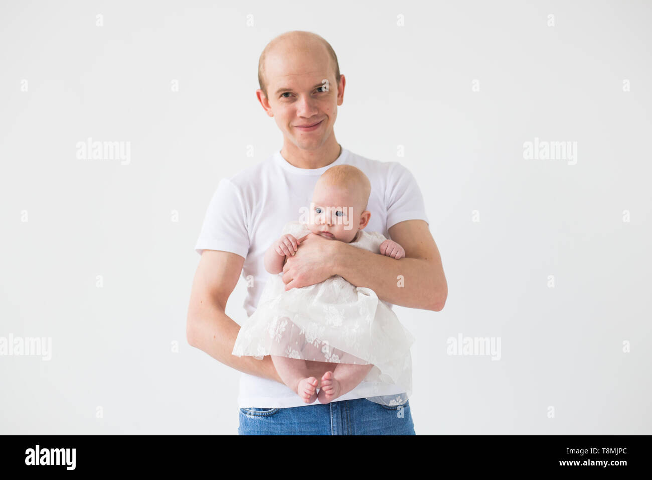 Childhood, family and fatherhood concept - proud bald father holding ...