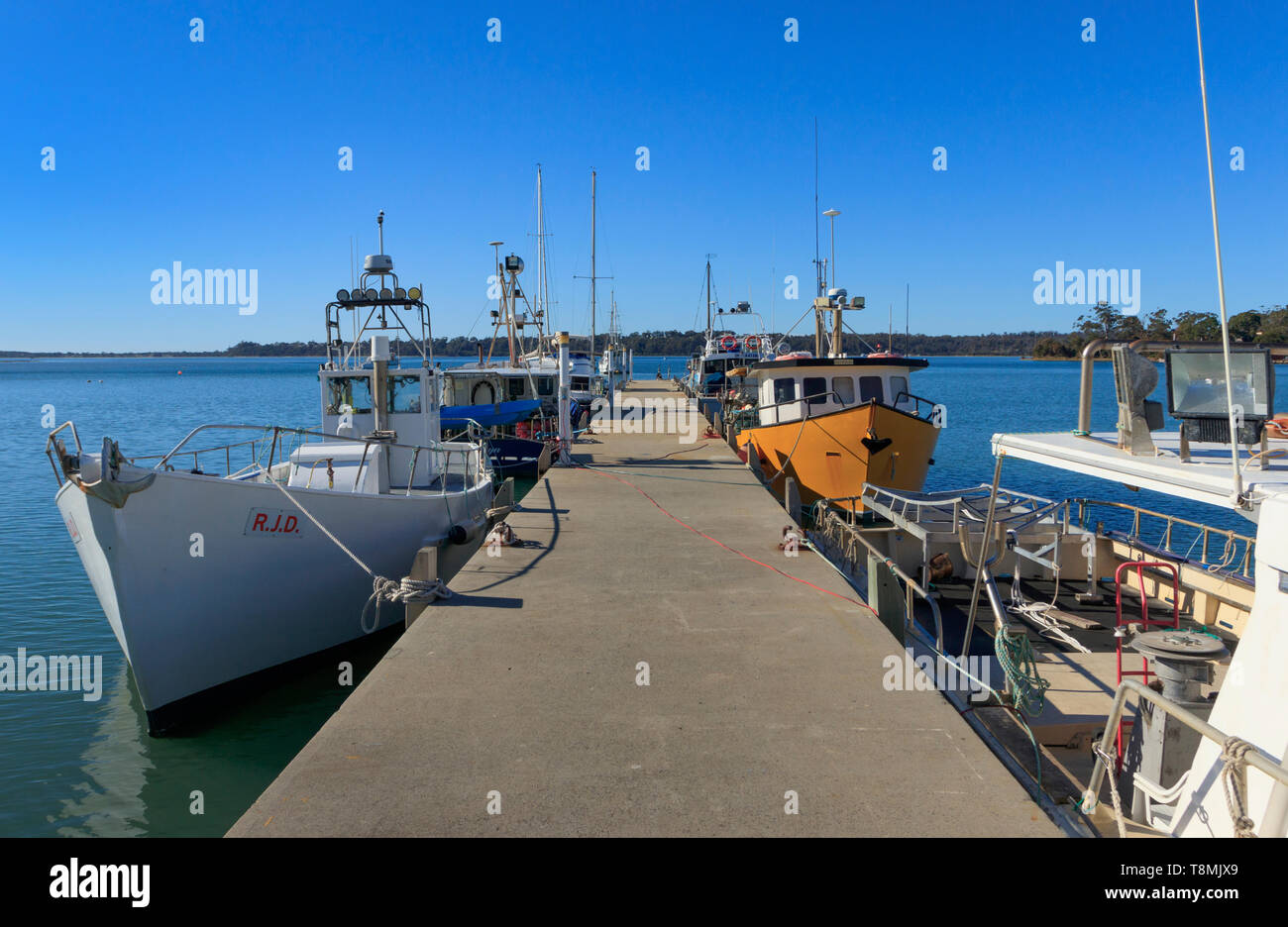 St Helens wharf with fishing boats tied up on the Bay of Fires East ...
