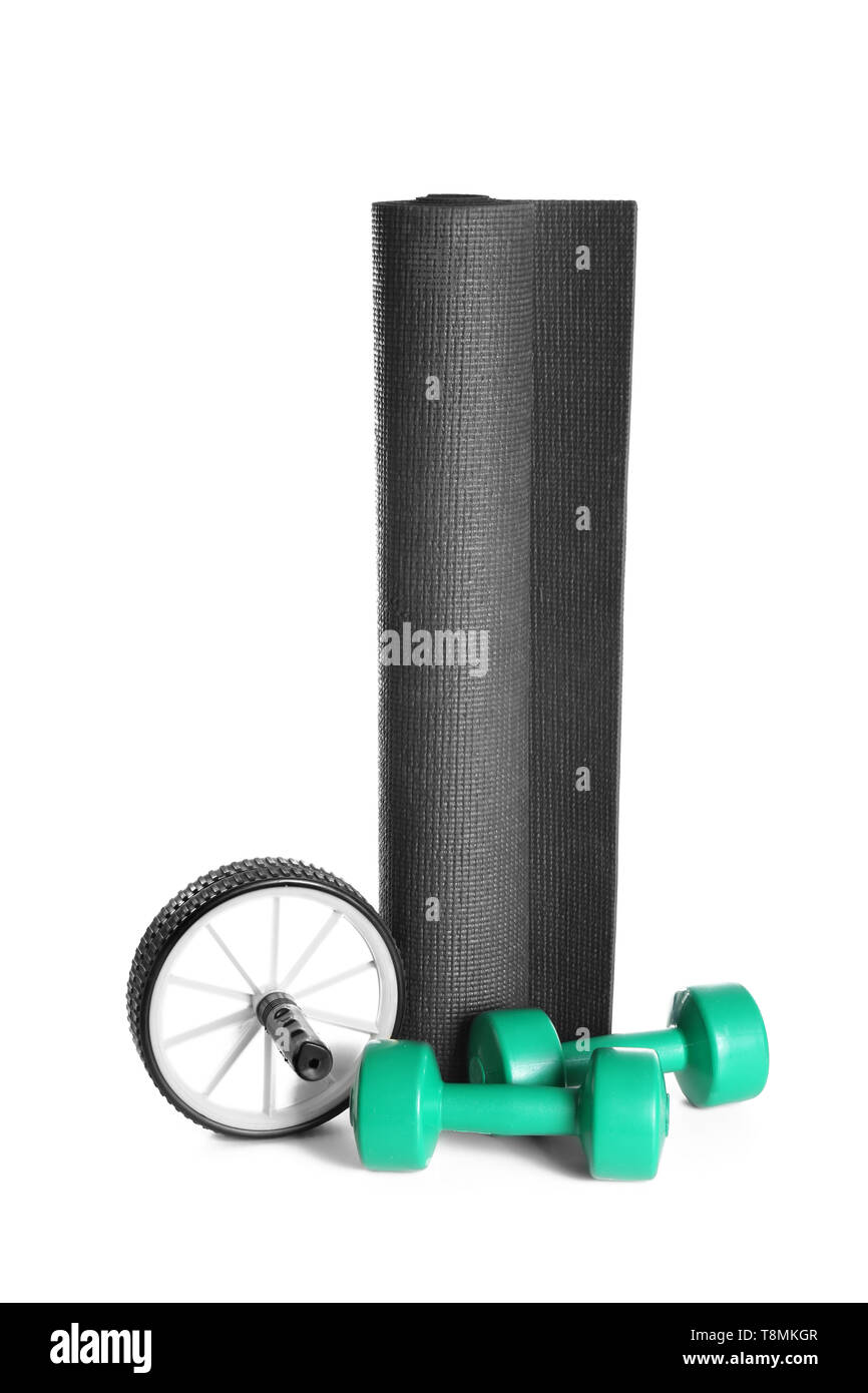 Yoga mat, dumbbells and roller wheel on white background Stock Photo ...