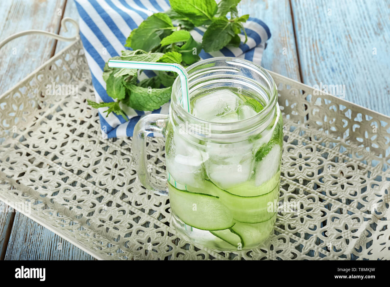 Mason jar of fresh cucumber water on tray Stock Photo - Alamy