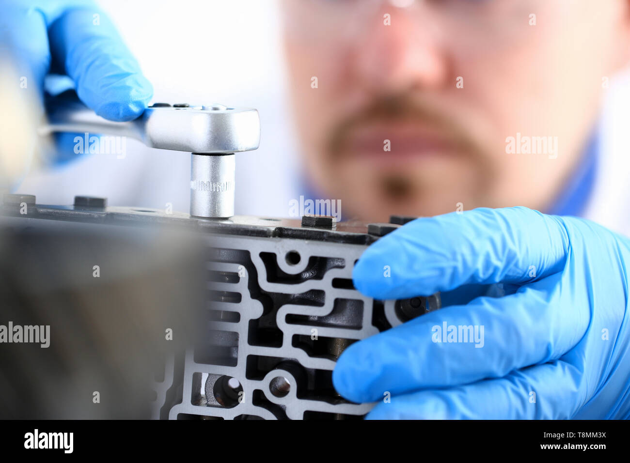 Repairman car-care center on repair of automatic Stock Photo - Alamy