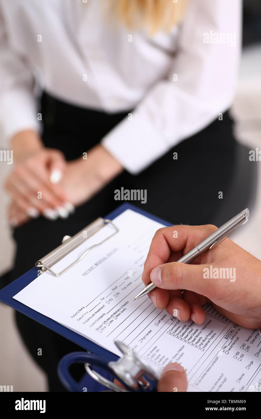 Male doctor arm hold silver pen filling patient Stock Photo - Alamy
