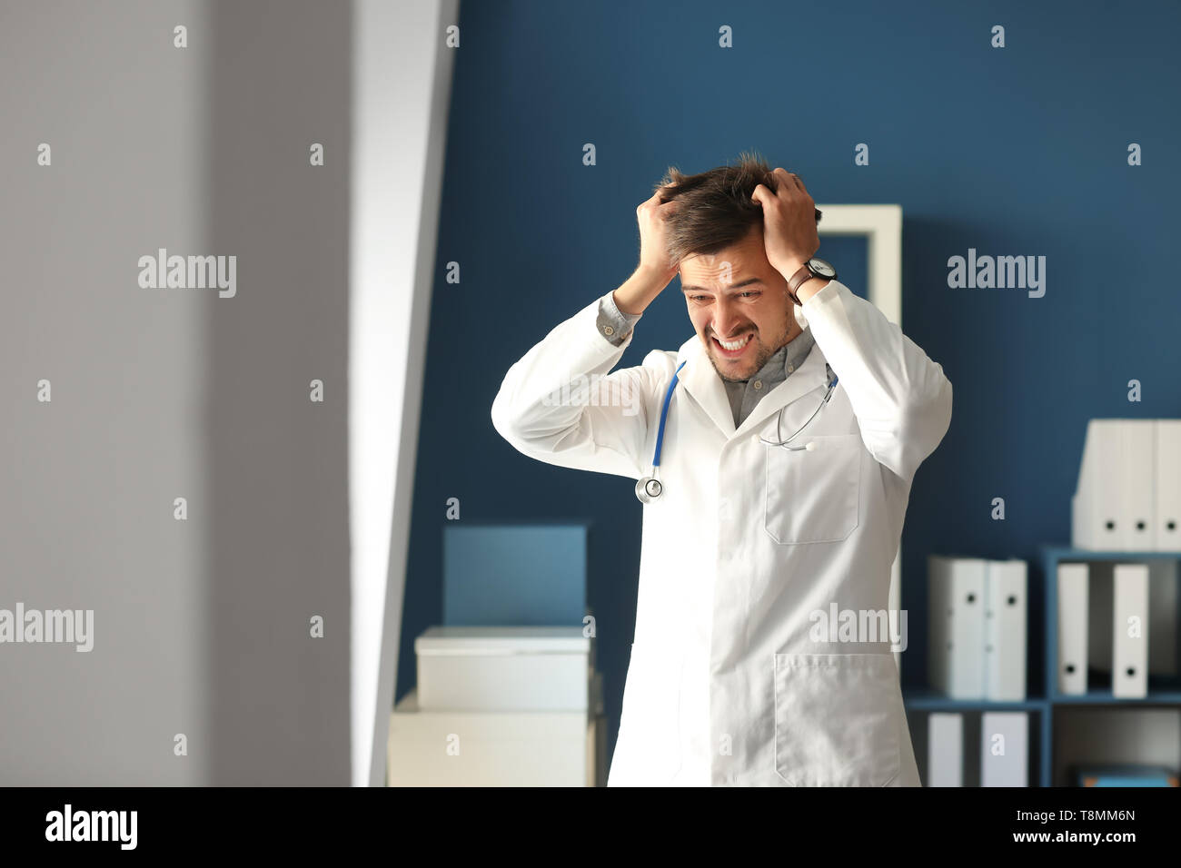 Stressed doctor in his office Stock Photo - Alamy