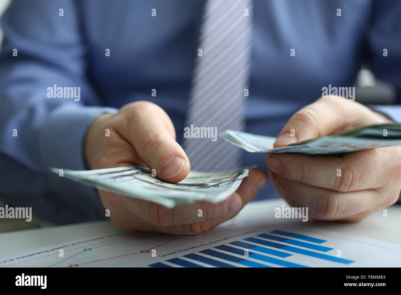 Male arm count hundred dollar bills closeup Stock Photo - Alamy