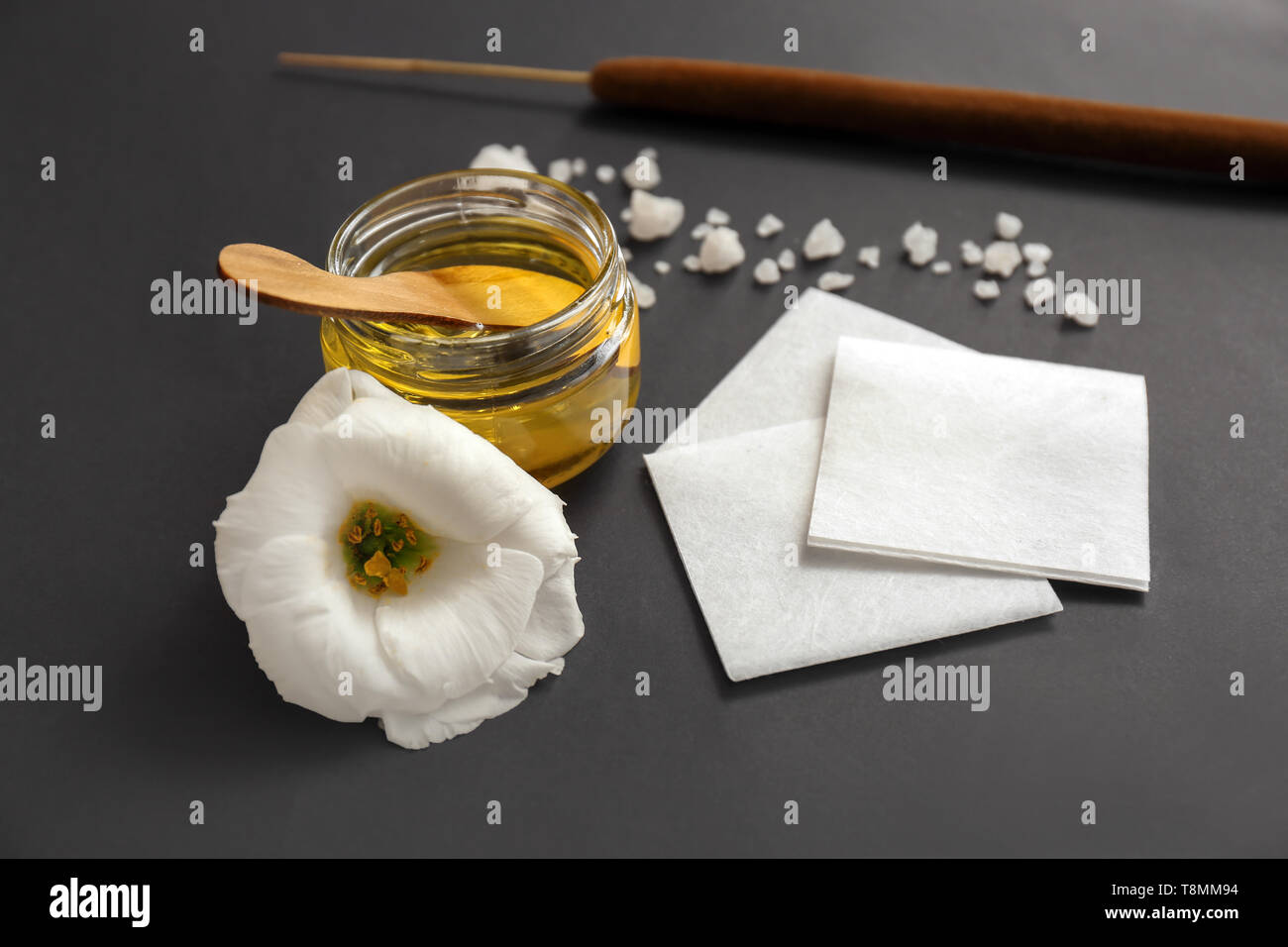 Jar with sugaring paste and strips on black background Stock Photo - Alamy