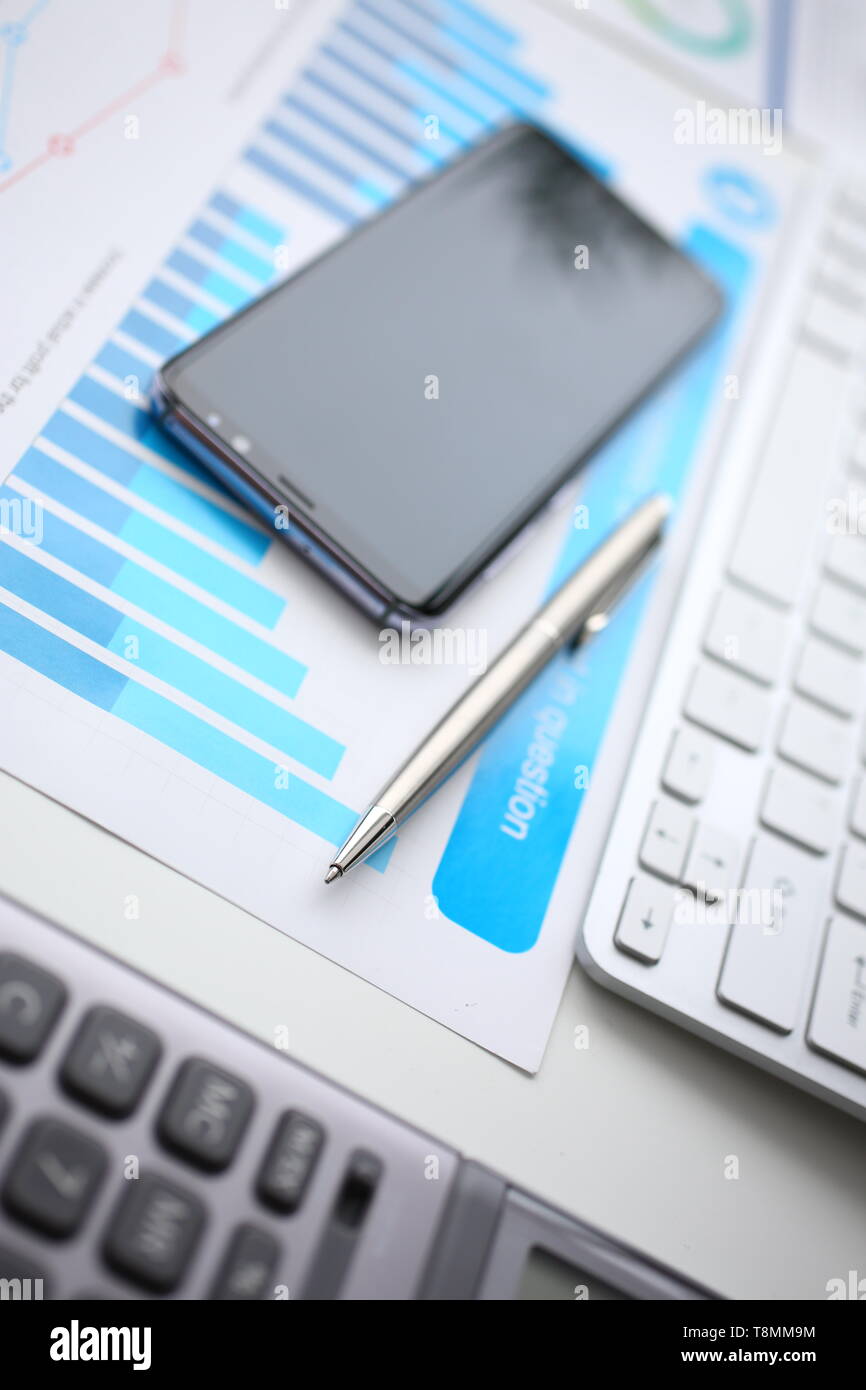 Silver calculator and financial statistics on clipboard Stock Photo - Alamy