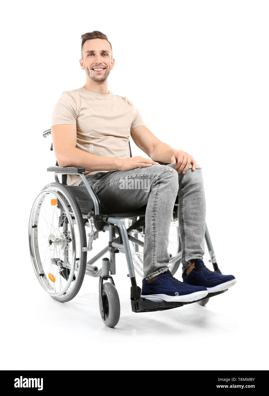 Young man sitting in wheelchair on white background Stock Photo - Alamy