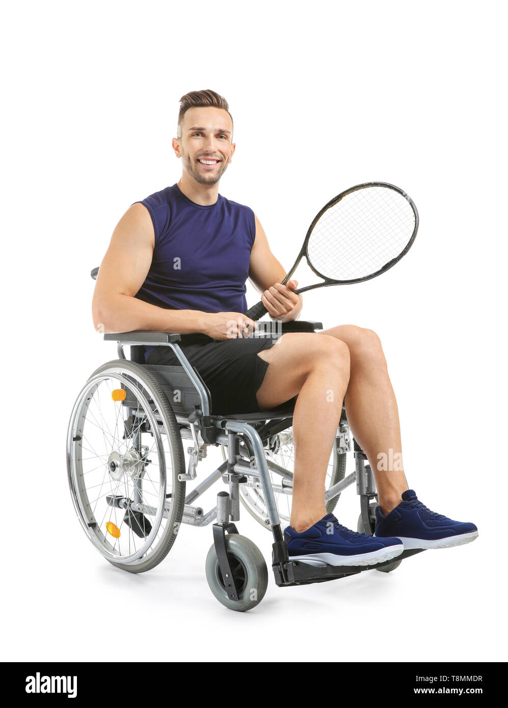Sporty young man with tennis racket sitting in wheelchair on white ...