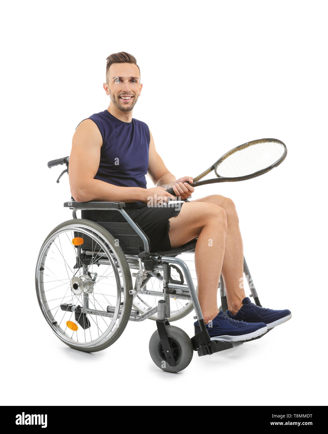 Sporty young man with tennis racket sitting in wheelchair on white ...
