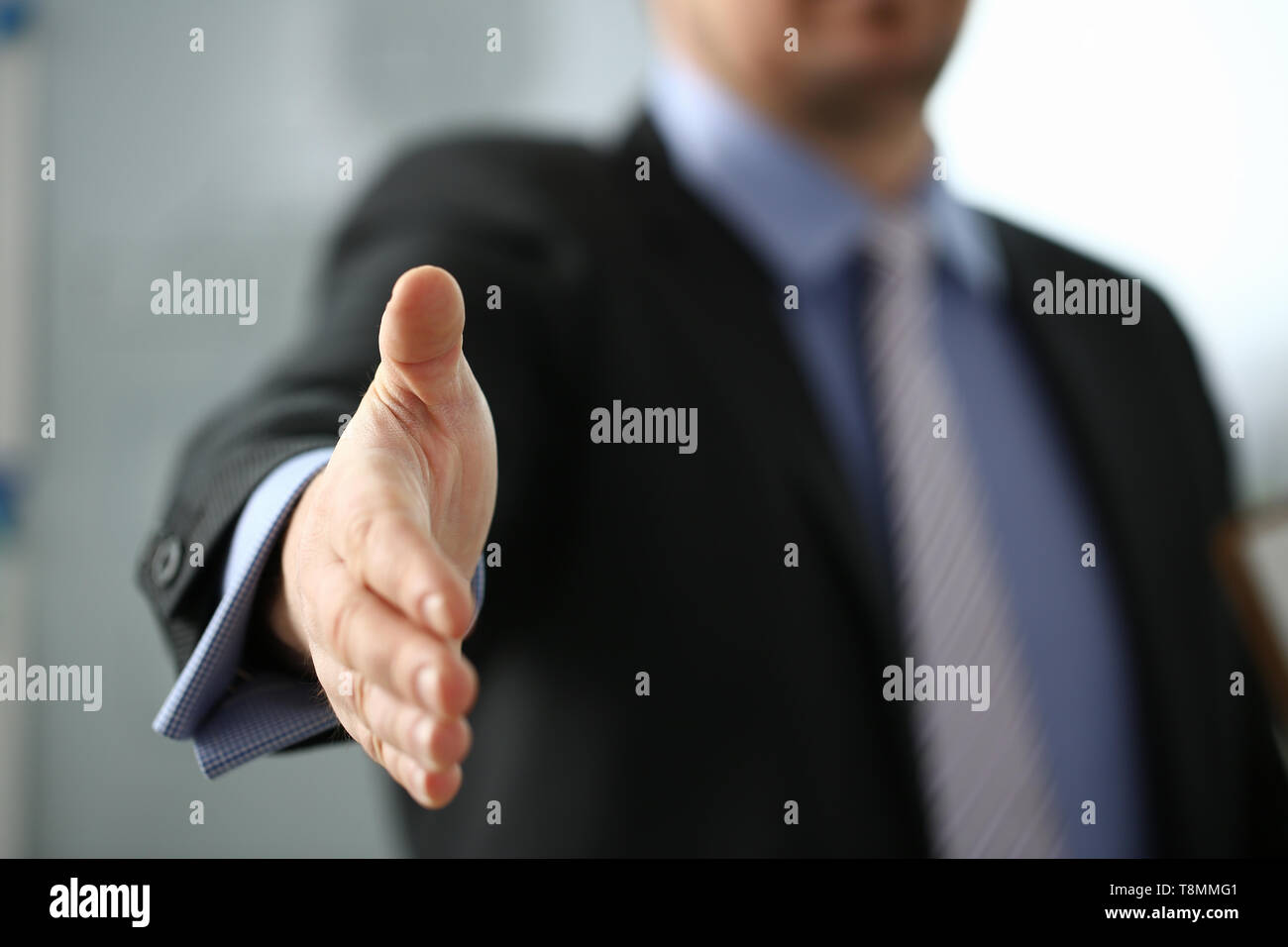 Man in suit and tie give hand as hello Stock Photo - Alamy