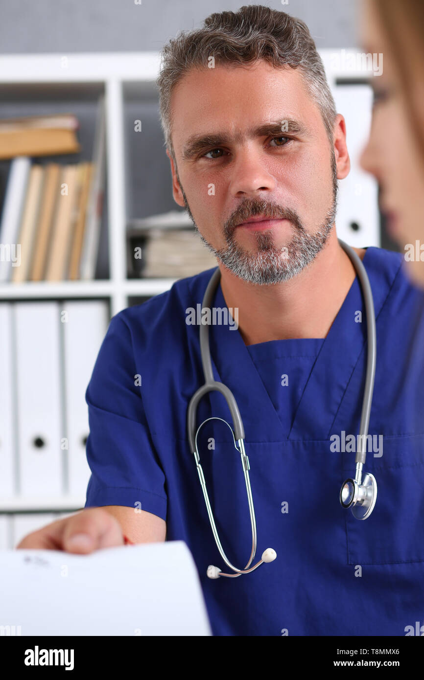 Male medicine doctor in blue uniform hold and give prescription Stock ...