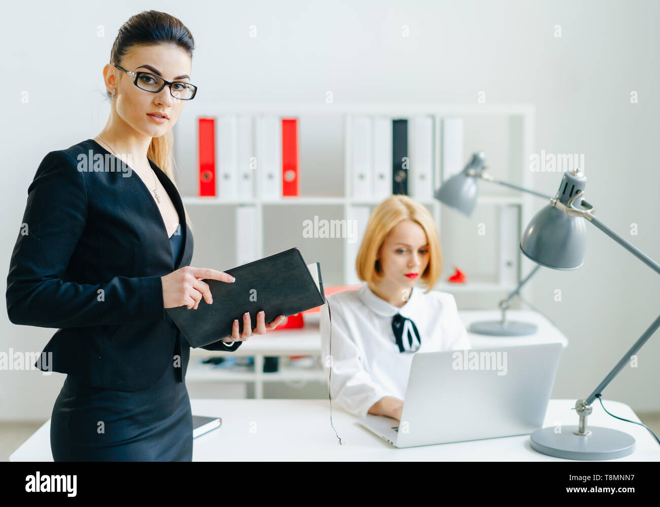Beautiful smiling cheerful girl at workplace look Stock Photo - Alamy