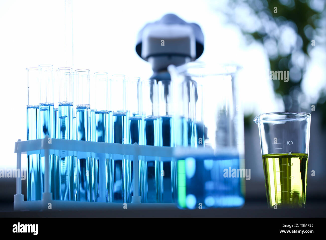 Test tube of glass overflows liquid solution potassium Stock Photo - Alamy