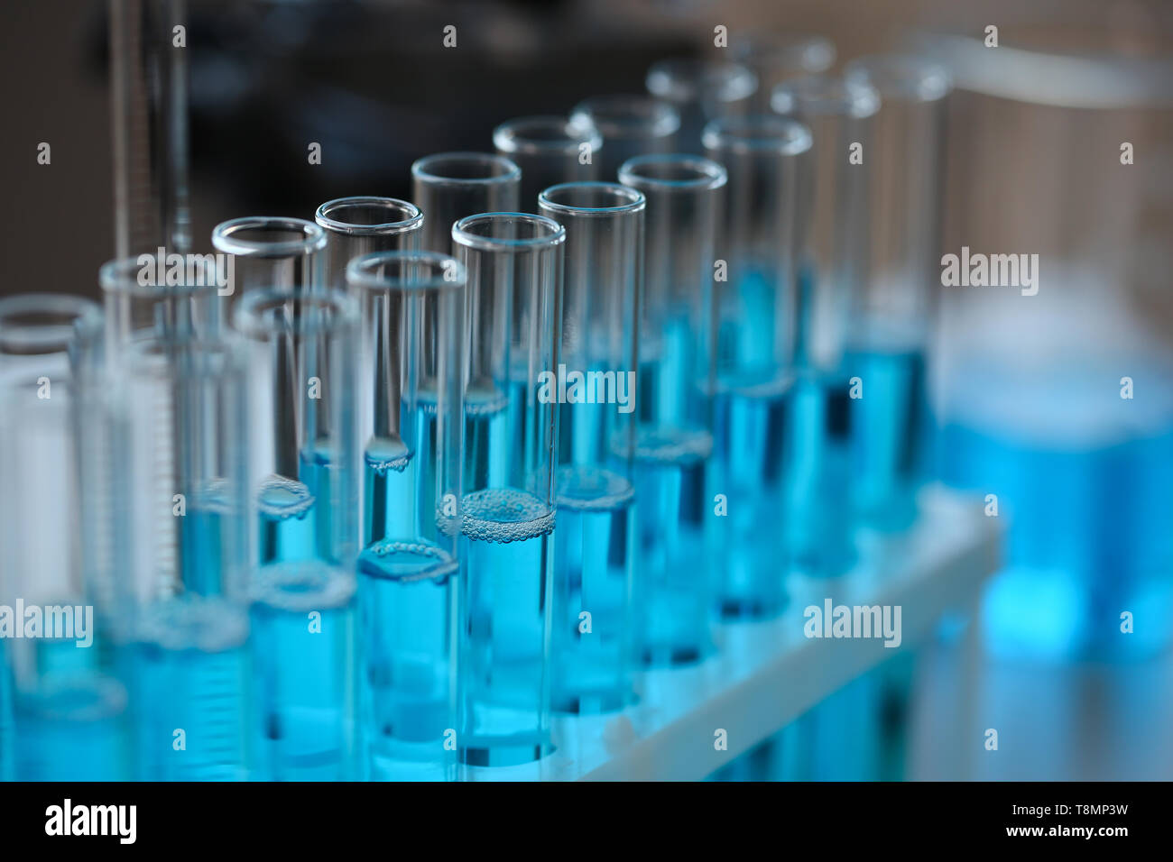 Test tube of glass overflows liquid solution potassium Stock Photo - Alamy