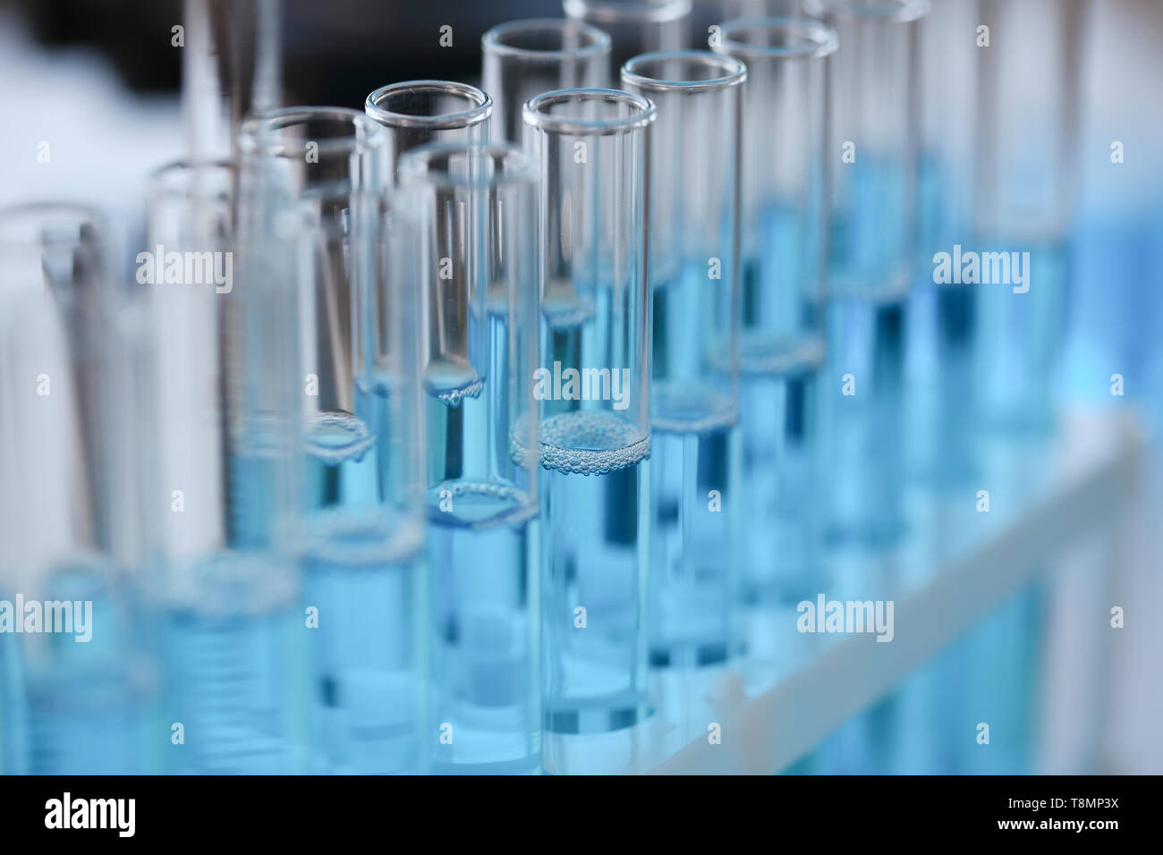 Test tube of glass overflows liquid solution potassium Stock Photo - Alamy
