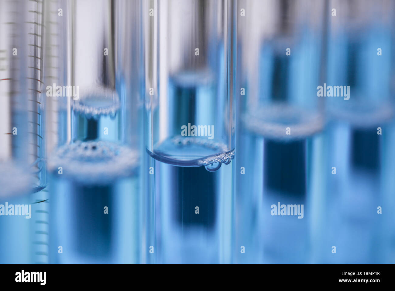 Test tube of glass overflows liquid solution potassium Stock Photo - Alamy