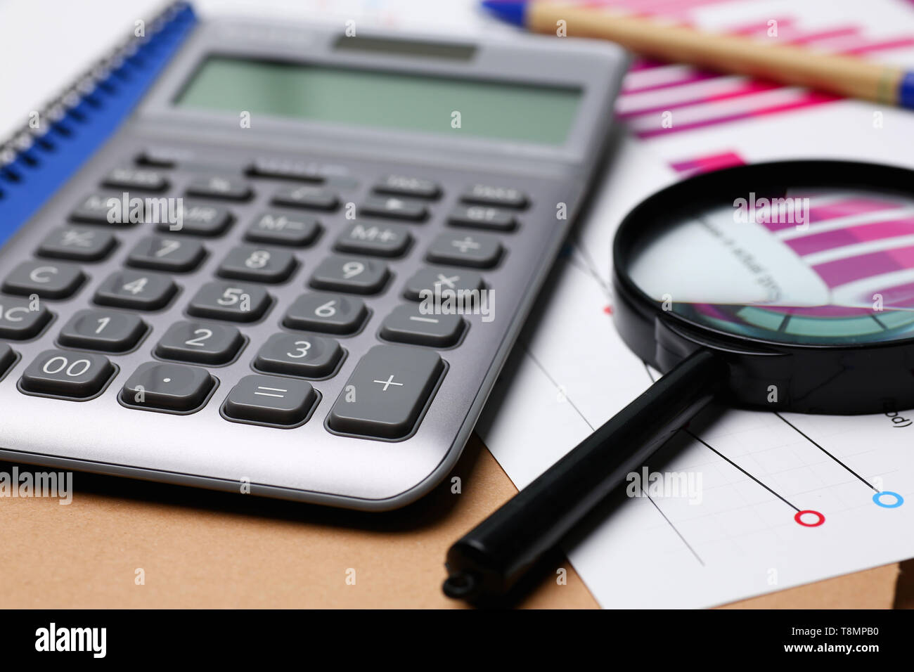 Silver calculator and financial statistics on clipboard Stock Photo - Alamy