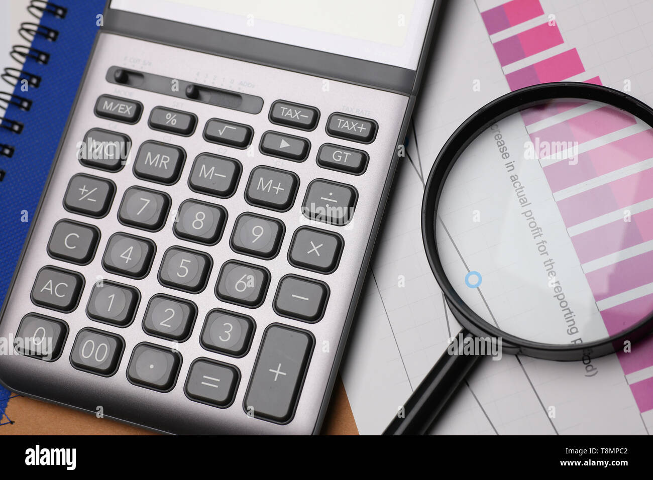 Silver calculator and financial statistics on clipboard Stock Photo - Alamy