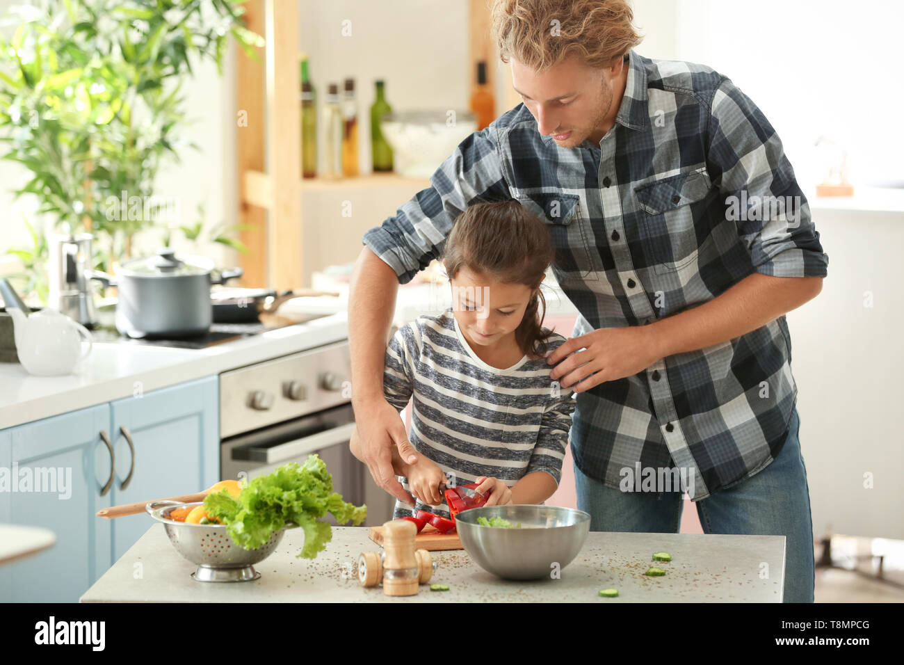 Father and daughter cooking together in kitchen Stock Photo - Alamy