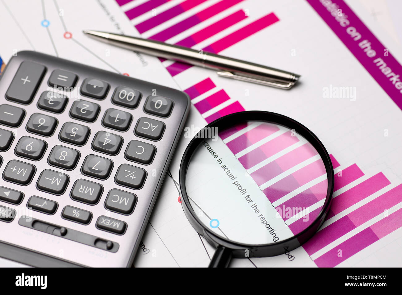 Silver calculator and financial statistics on clipboard Stock Photo - Alamy