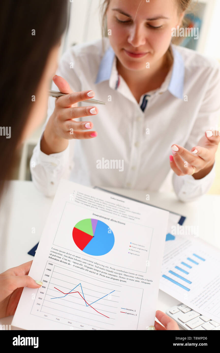 Beautiful woman portrait at workplace examining Stock Photo - Alamy