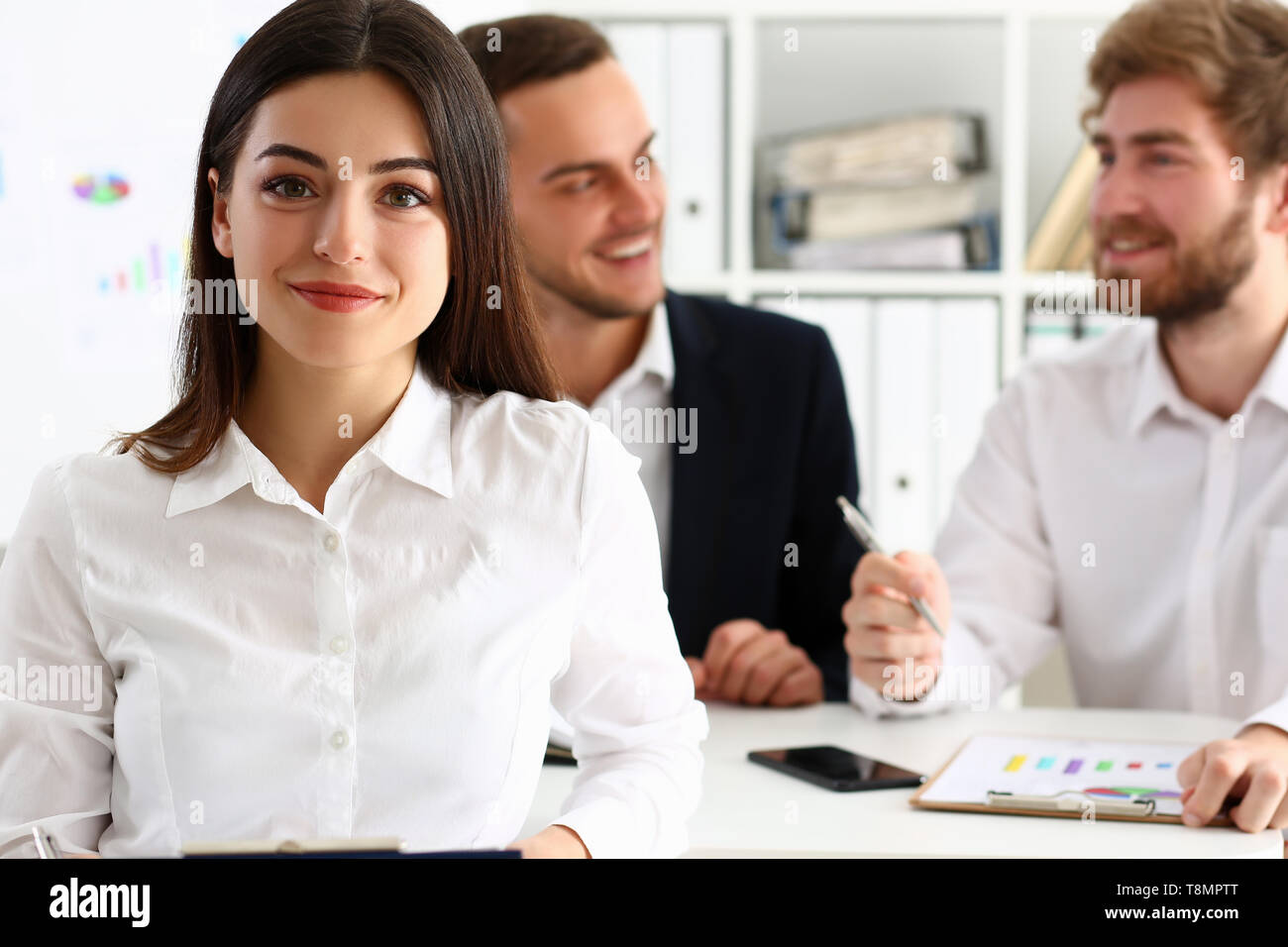 Beautiful smiling cheerful girl at workplace look Stock Photo - Alamy
