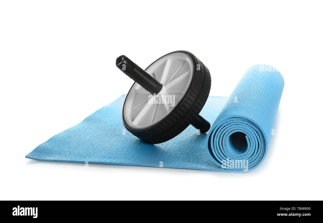 Yoga mat and roller wheel on white background Stock Photo - Alamy