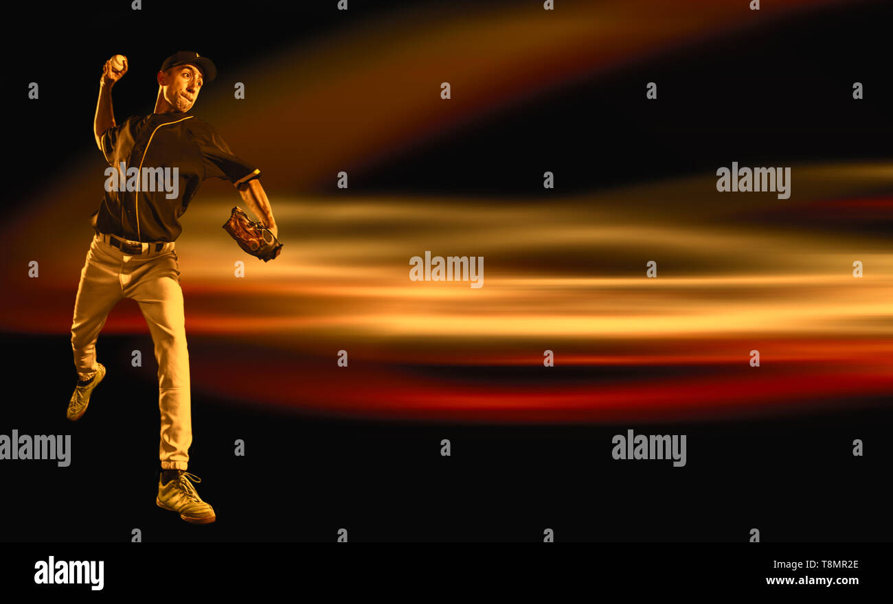 One caucasian man as baseball player playing against dark neon ...