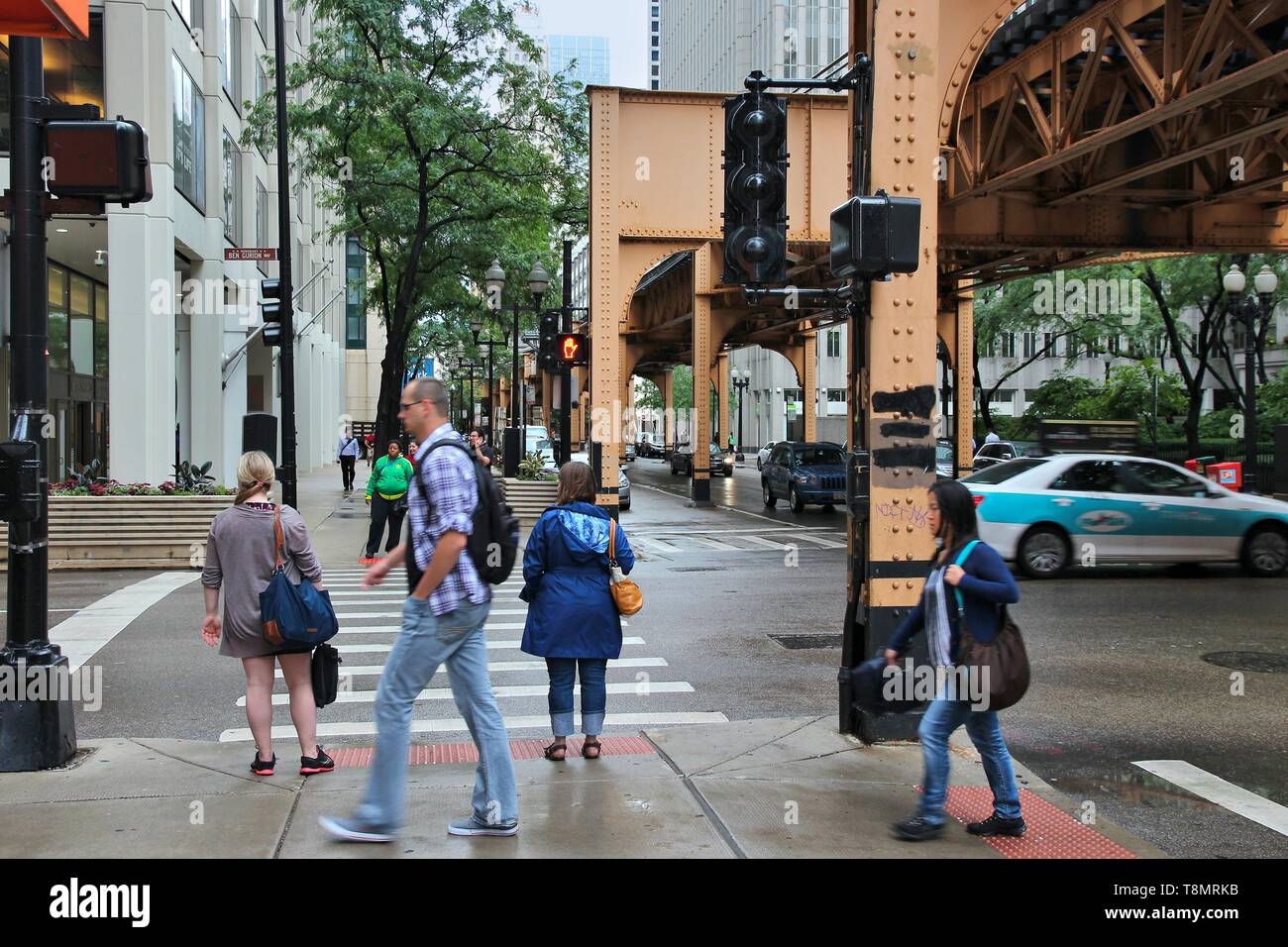 CHICAGO, USA - JUNE 26, 2013: People walk beneath "El" tracks in ...