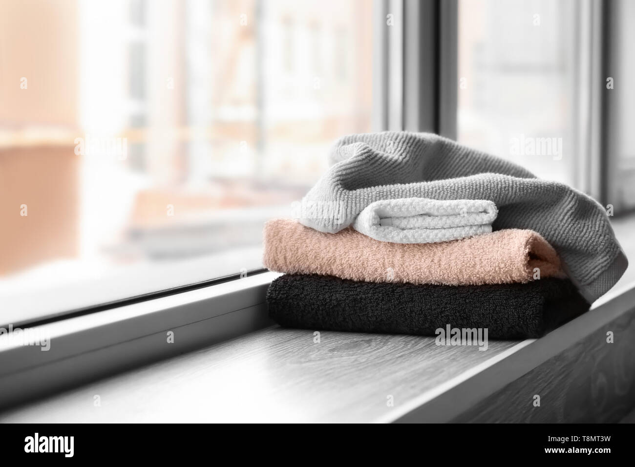 Clean towels on windowsill Stock Photo - Alamy