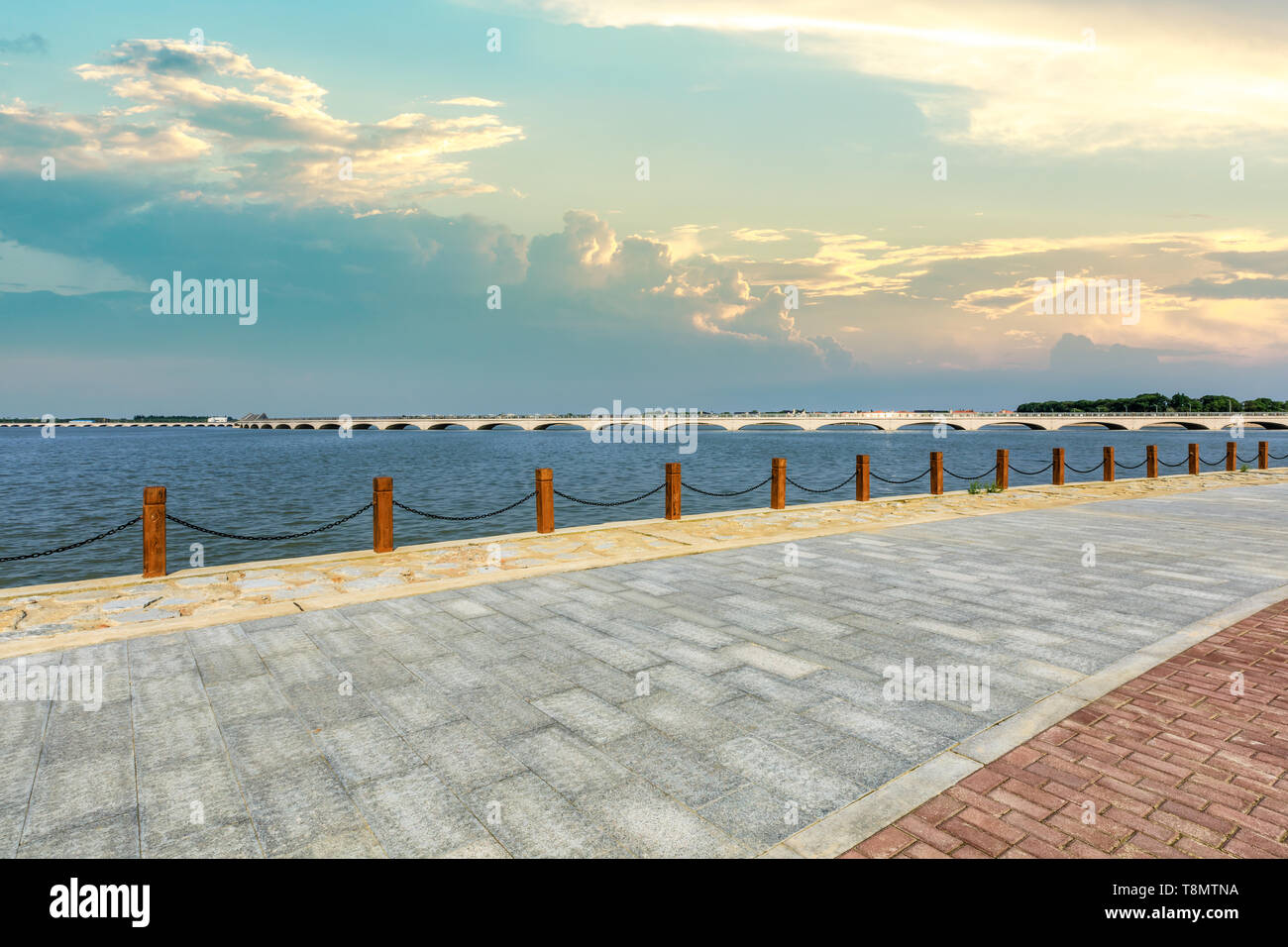 Beautiful lake and walkway with sky clouds at sunset Stock Photo - Alamy