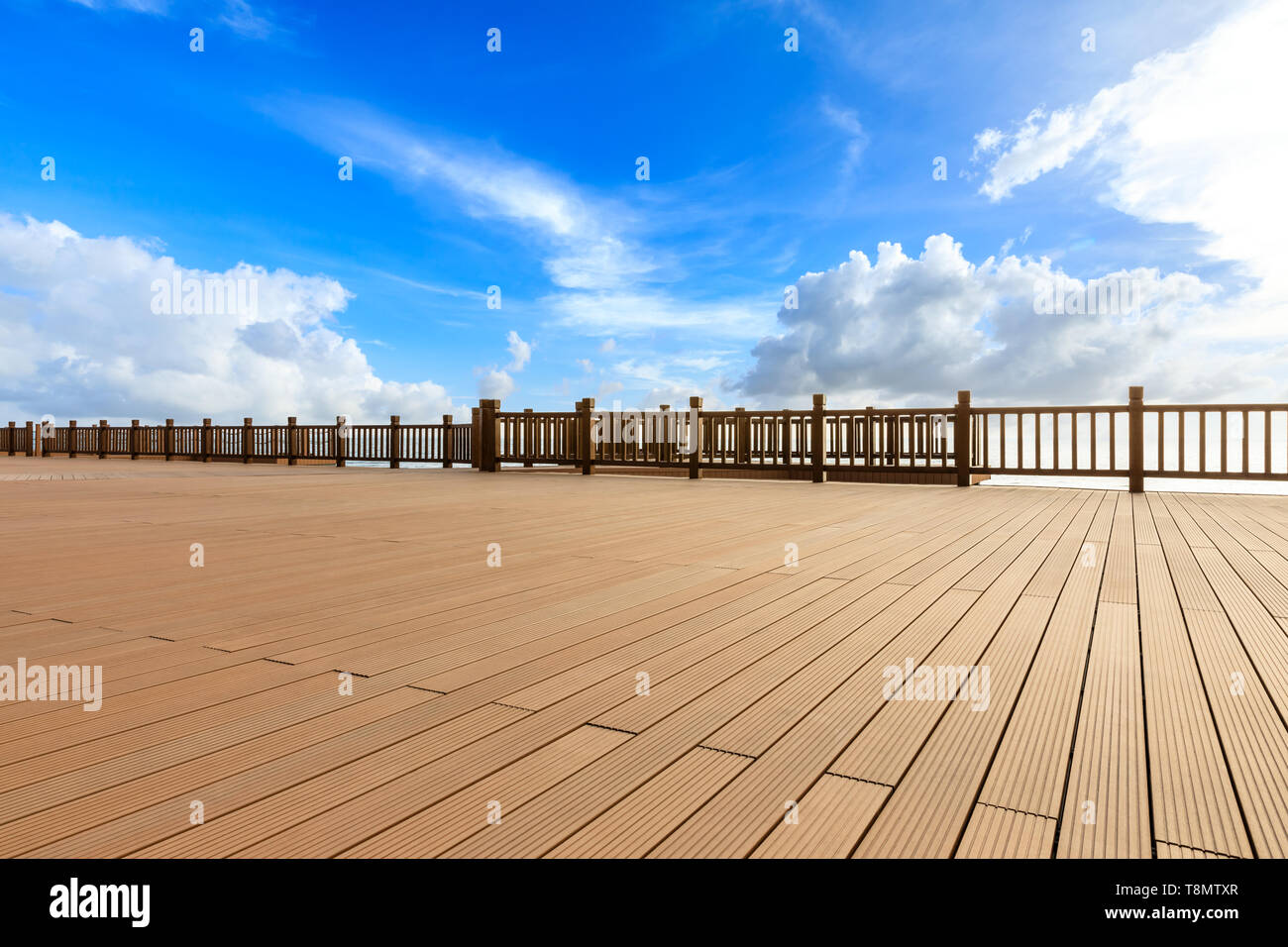 Lakeside wood floor platform and blue sky with white clouds Stock Photo ...
