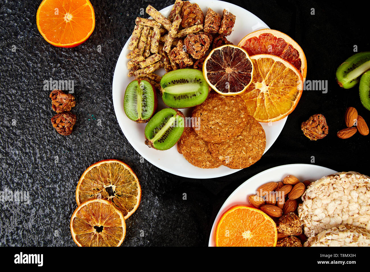 Healthy snacks on white plates - variety oat granola bar, rice crips ...