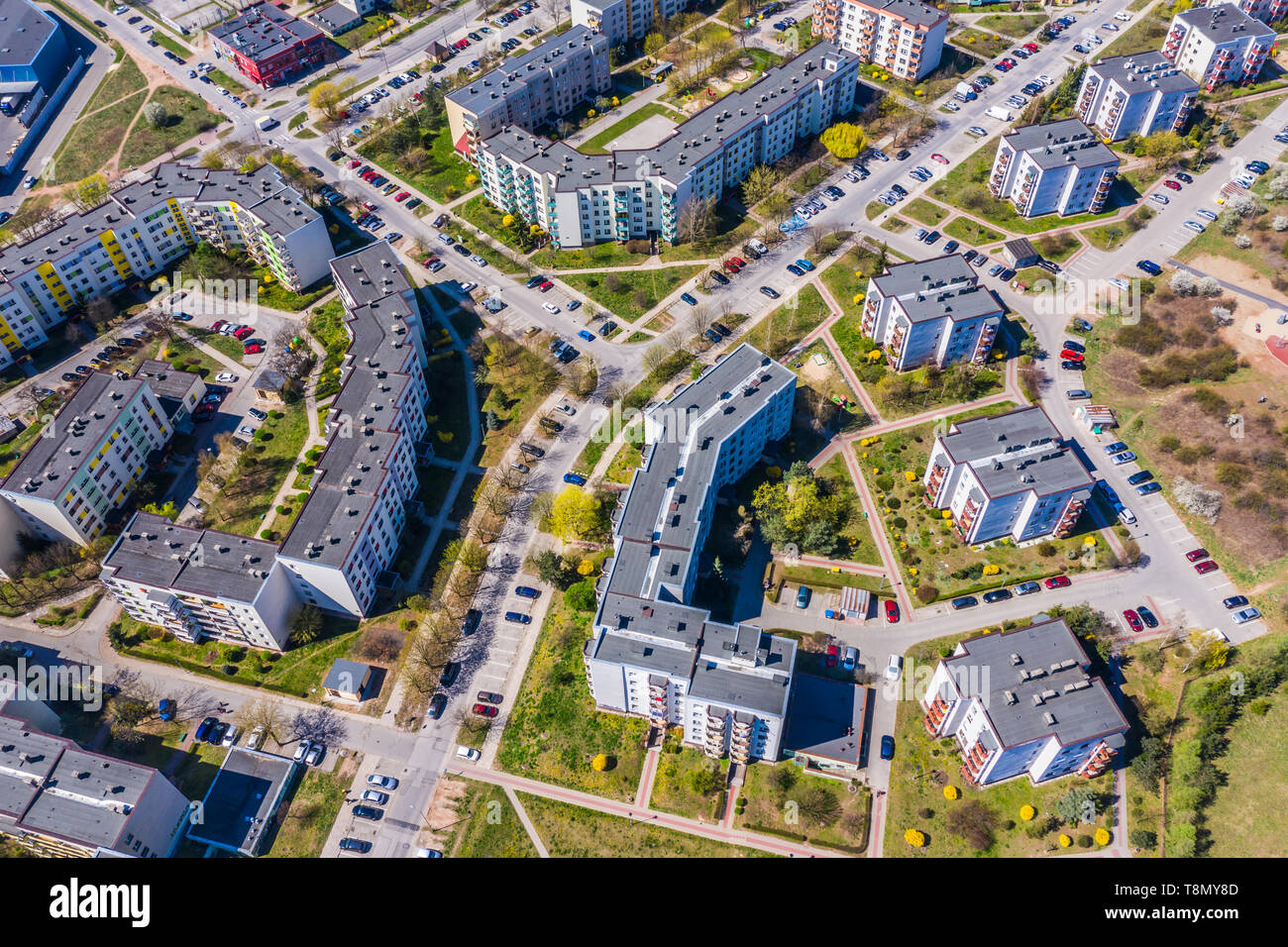 Aerial city view with crossroads and roads, houses, buildings, parks ...