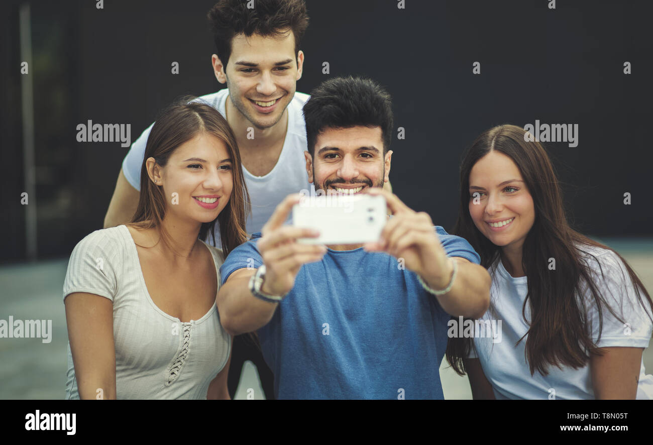 Group of friend taking a selfie picture together Stock Photo - Alamy