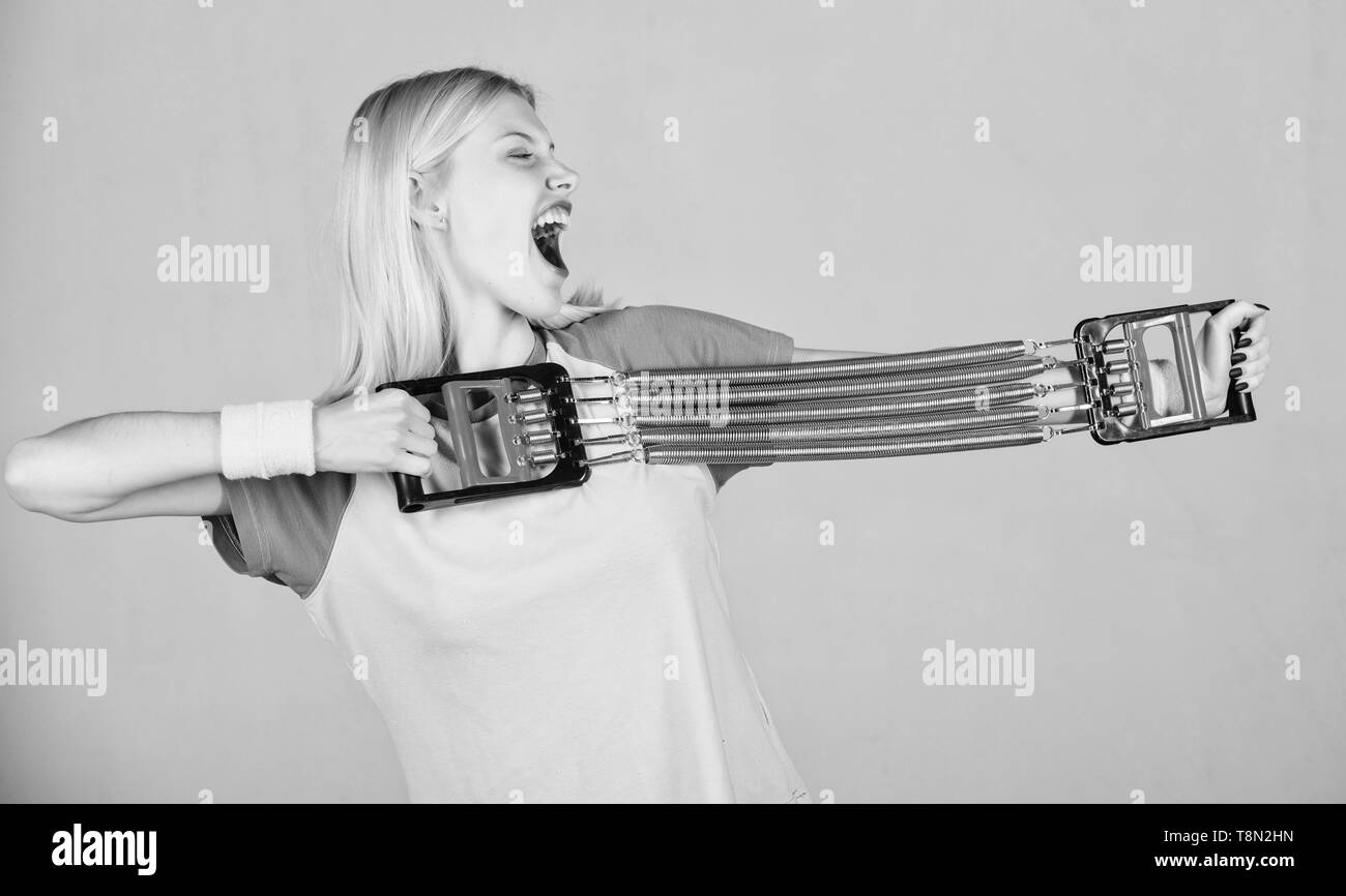 Woman exercising chest expander hi-res stock photography and images - Alamy