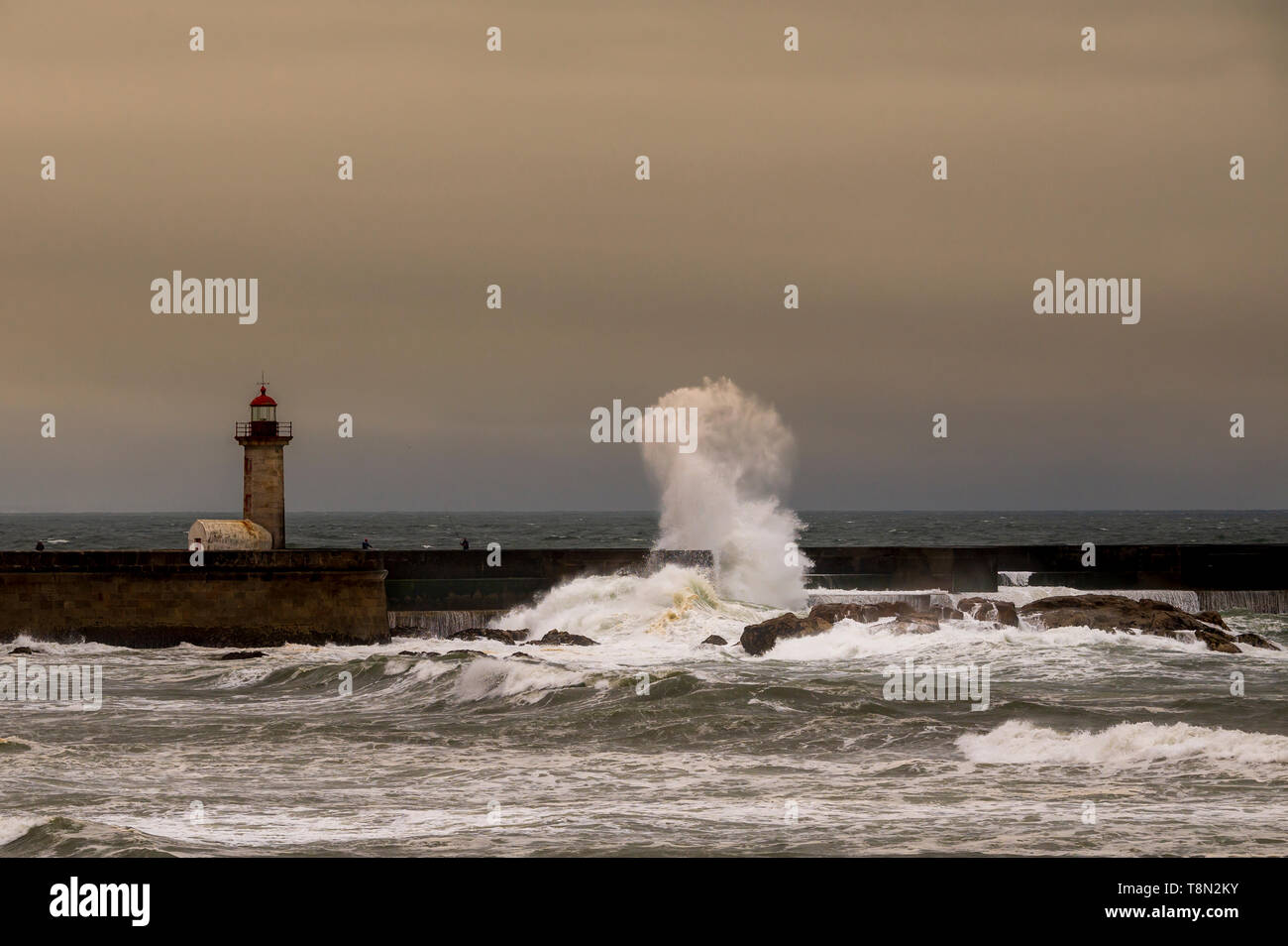 Las Felgueras lighthouse in Portocon the rough sea and stormy spring ...