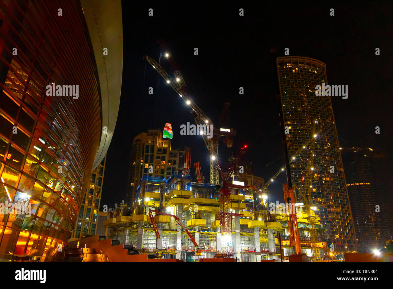 Construction of a large city building at night Stock Photo - Alamy