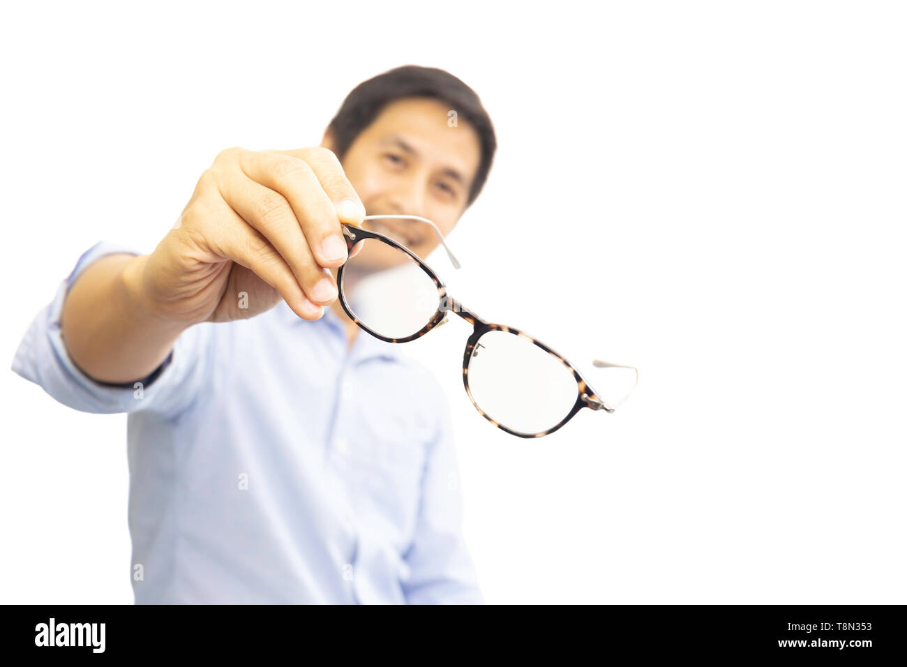 Man holding eyeglasses for a try out isolated in clipping path Stock ...