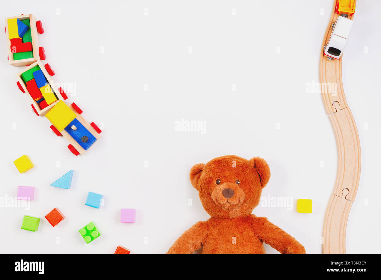 Baby kids toys background. Teddy bear, wooden train, colorful bricks on ...