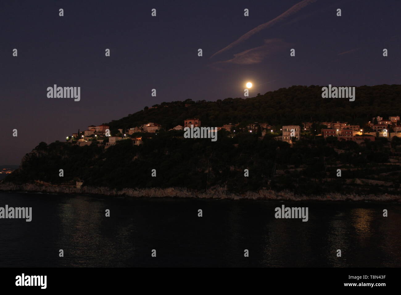 The moon setting at dawn over the French Riviera Stock Photo - Alamy