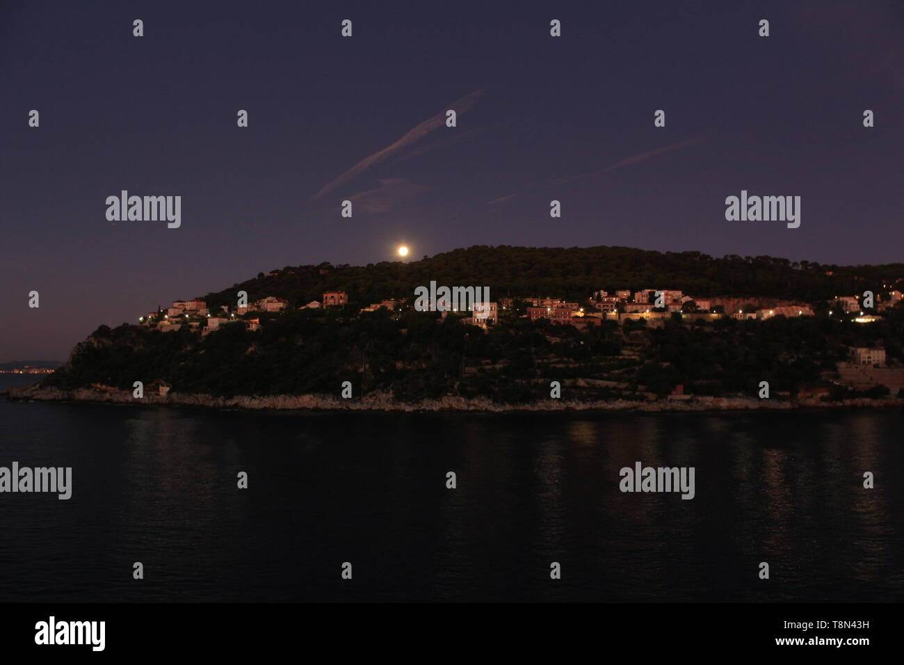 The moon setting at dawn over the French Riviera Stock Photo - Alamy
