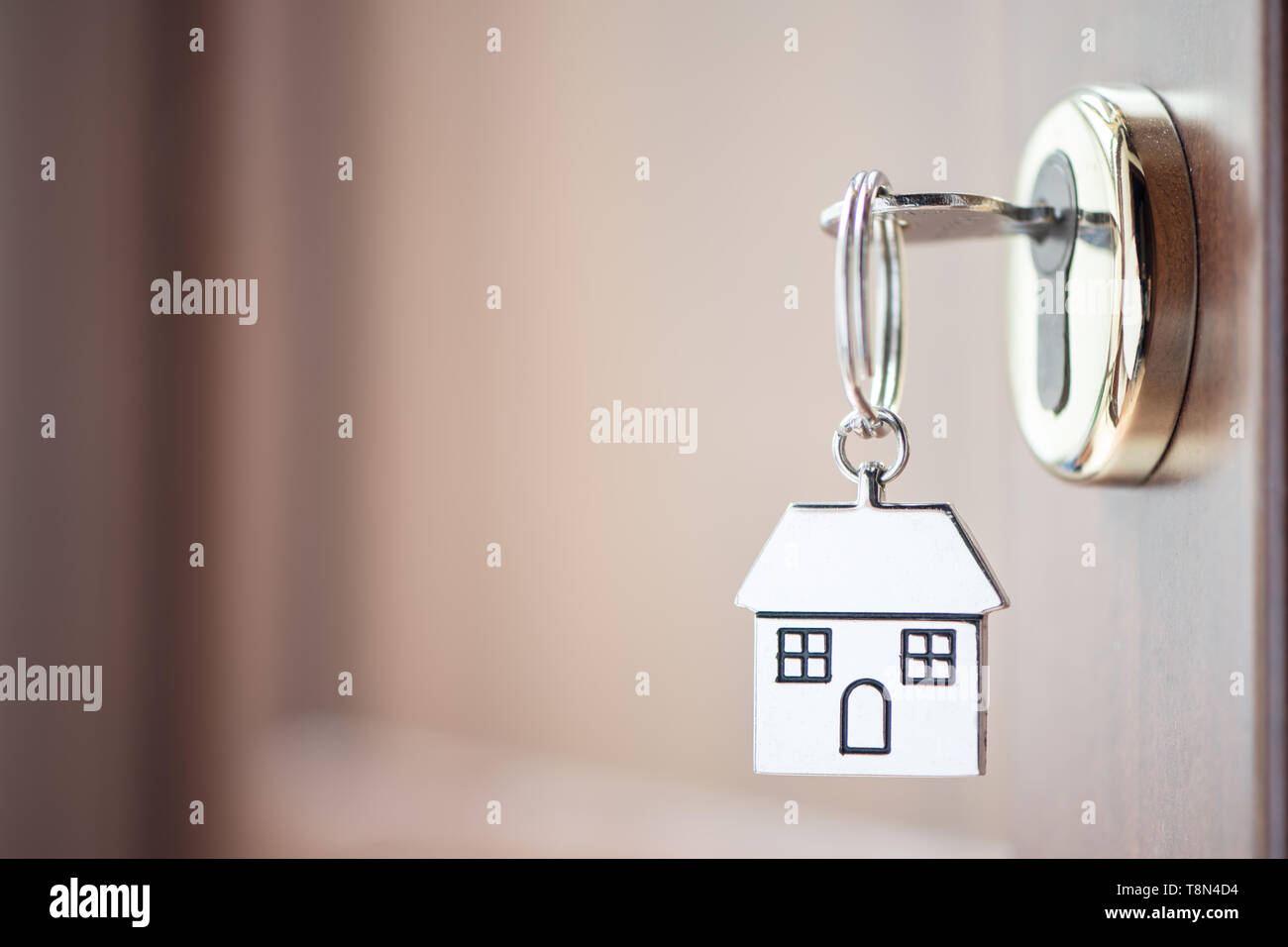 House key in the door. Close up Stock Photo - Alamy