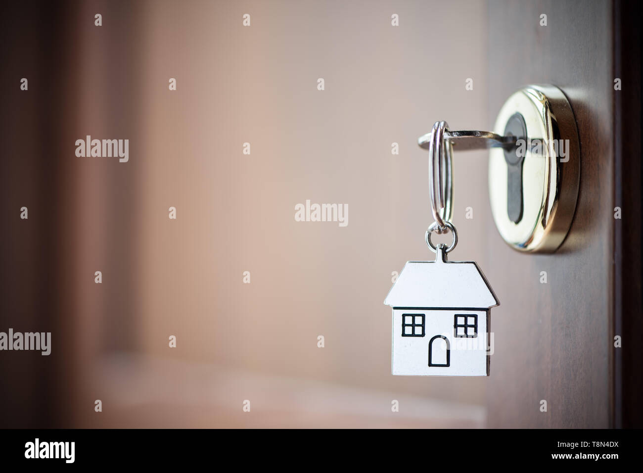 House key in the door. Close up Stock Photo - Alamy
