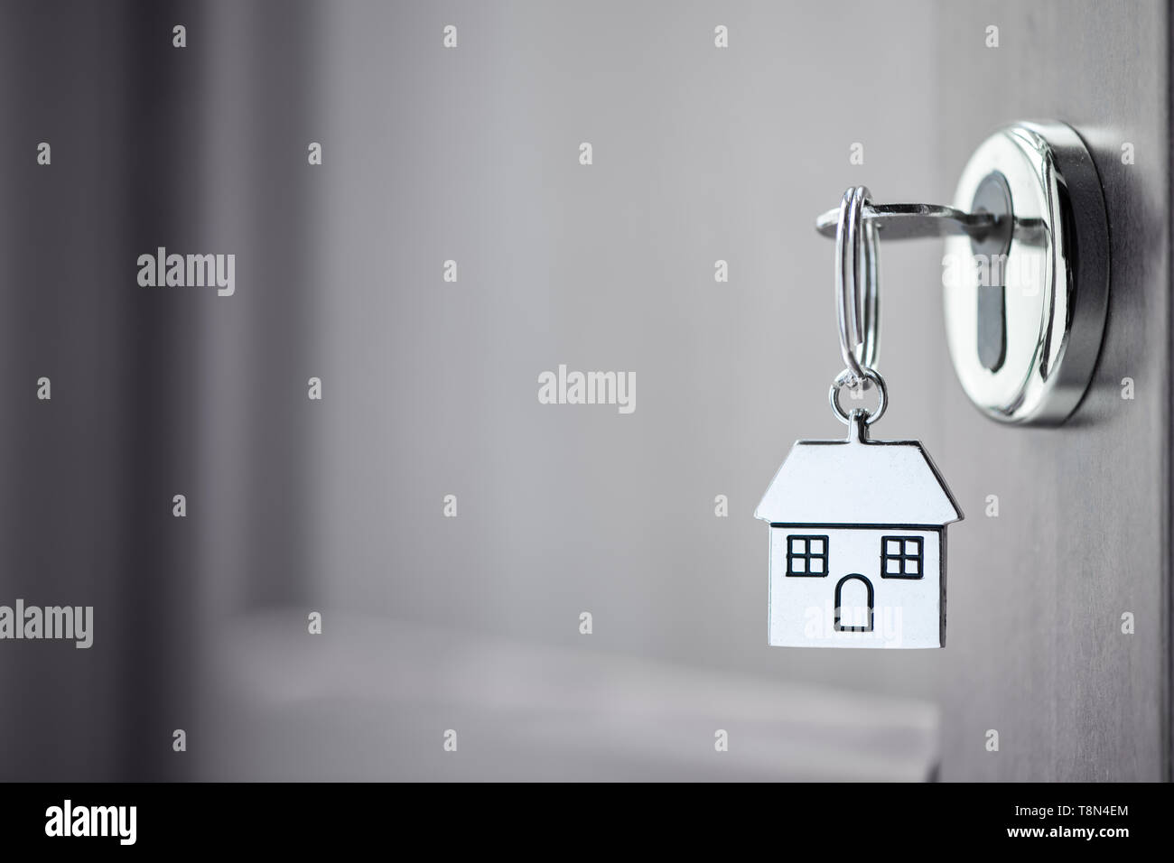 House key in the door. Close up Stock Photo - Alamy