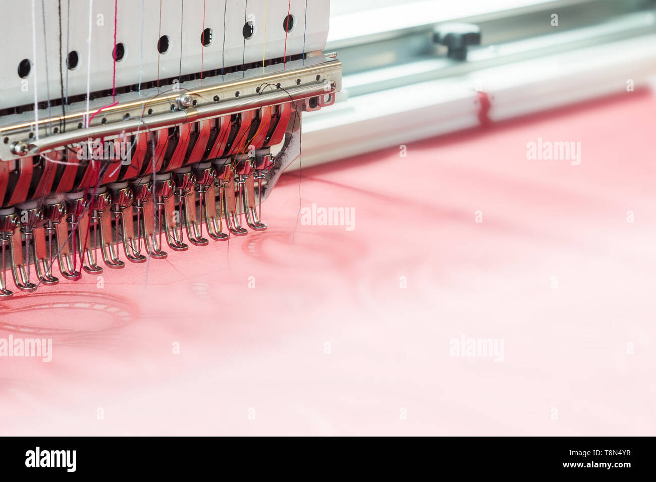 Industrial embroidery machine in textile production workshop. Close-up ...